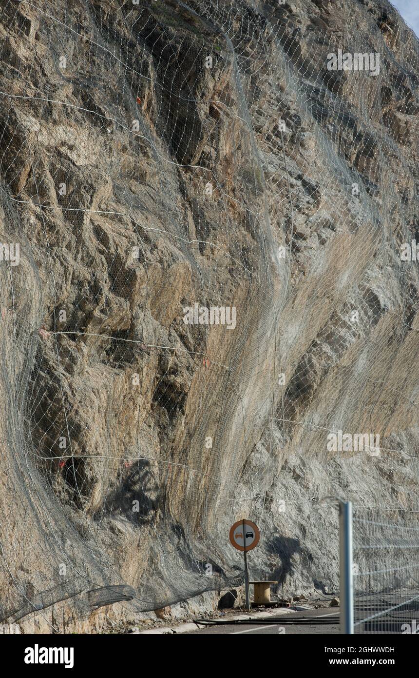metal mesh on the mountain to prevent rockslide on the road Stock Photo ...