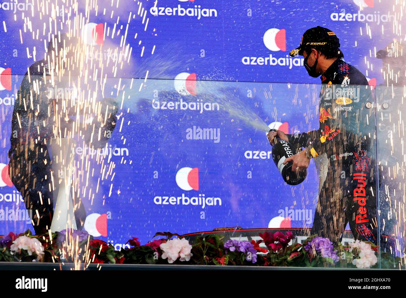 Race winner Sergio Perez (MEX) Red Bull Racing celebrates on the podium ...