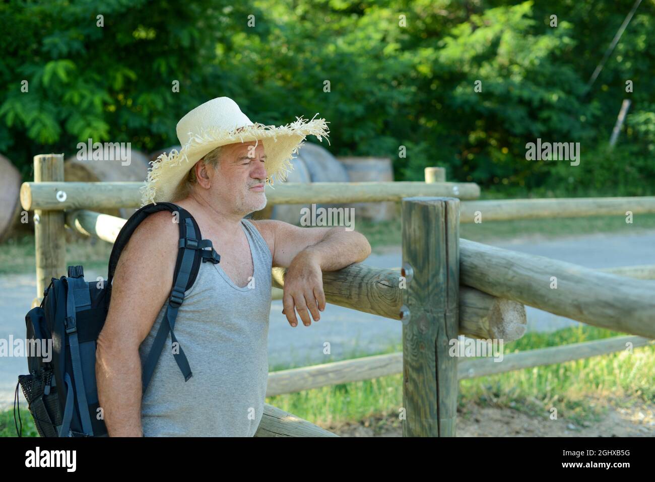View of a villager standing near the fence of a round pen Stock Photo ...