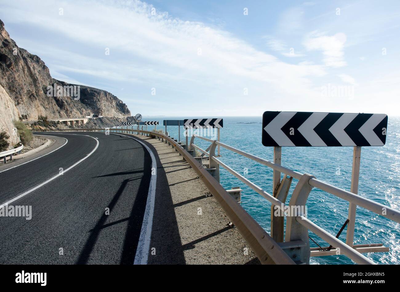 dangerous curve, road sign on the edge of the cliff, coast road Stock ...