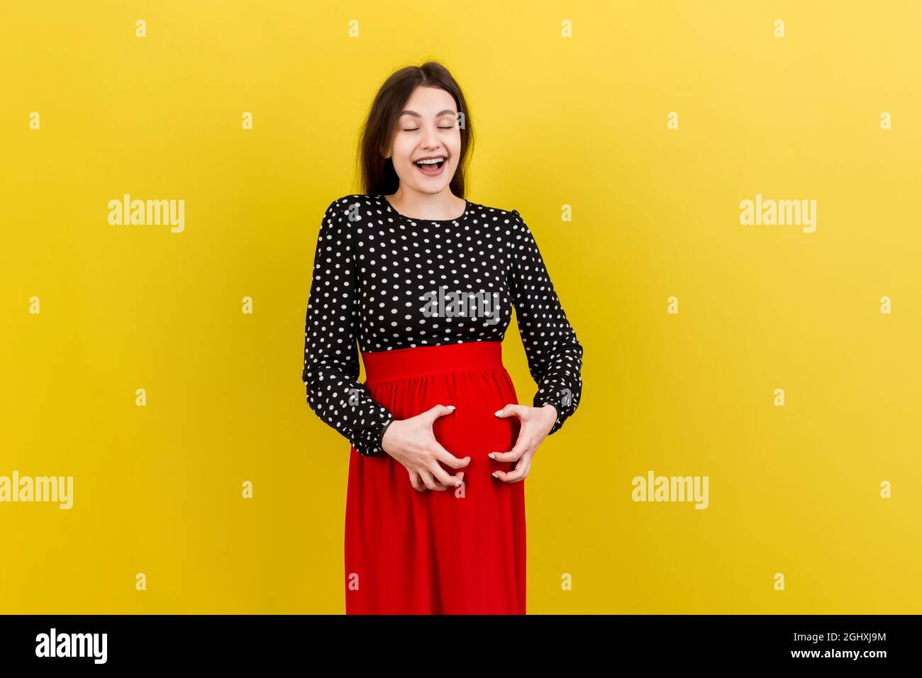 Pregnant woman scratching her belly on colored background Stock Photo ...