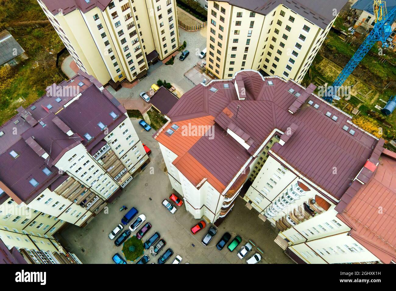 Aerial view of parked cars on parking lot between high apartment ...