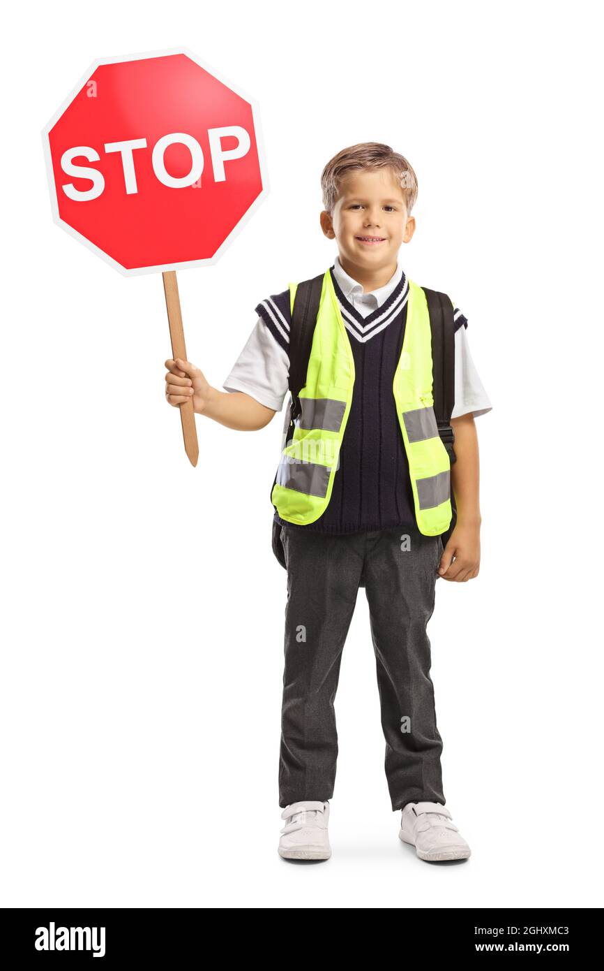 Little schoolboy with a safety vest and a stop traffic sign looking at ...