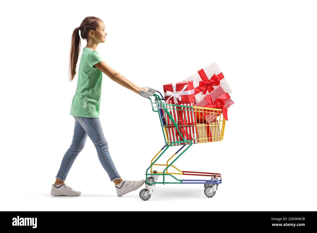 Full length profile shot of a child pushing a shopping cart with ...