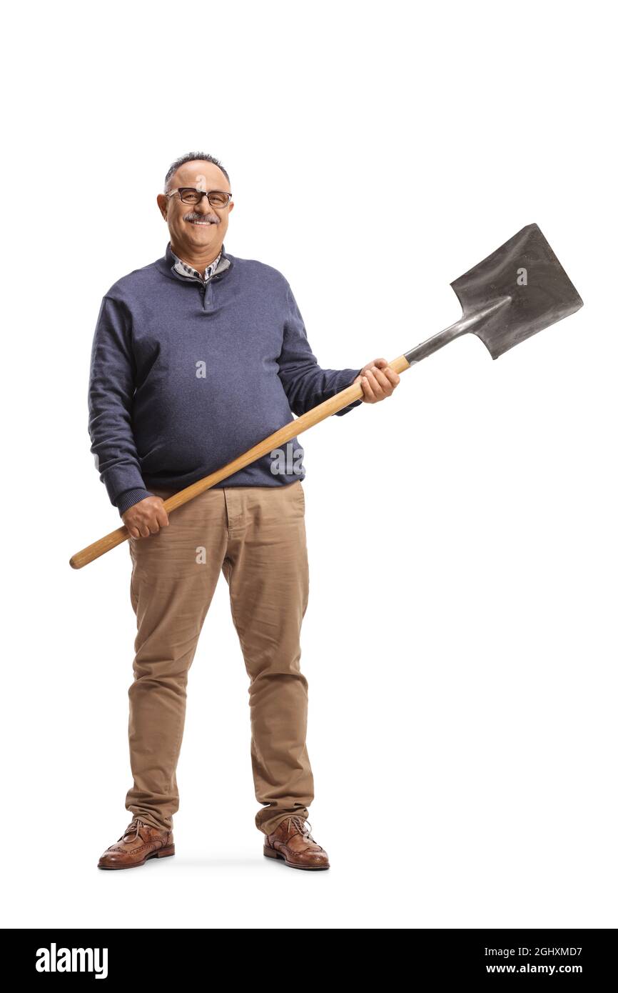 Mature smiling man in casual clothes holding a shovel isolated on white ...