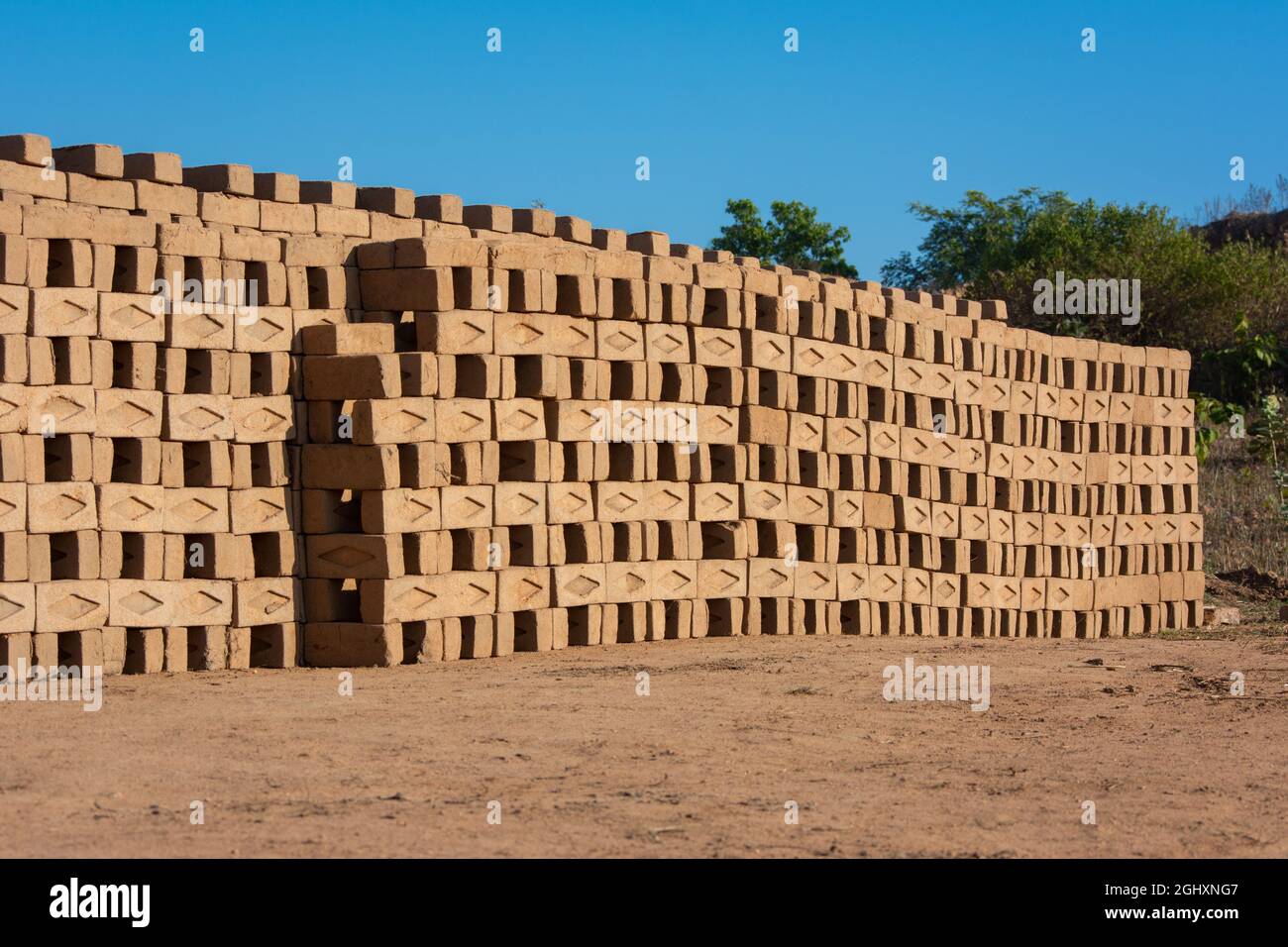 Hand made bricks from wet clay and mud are kept for drying before the ...