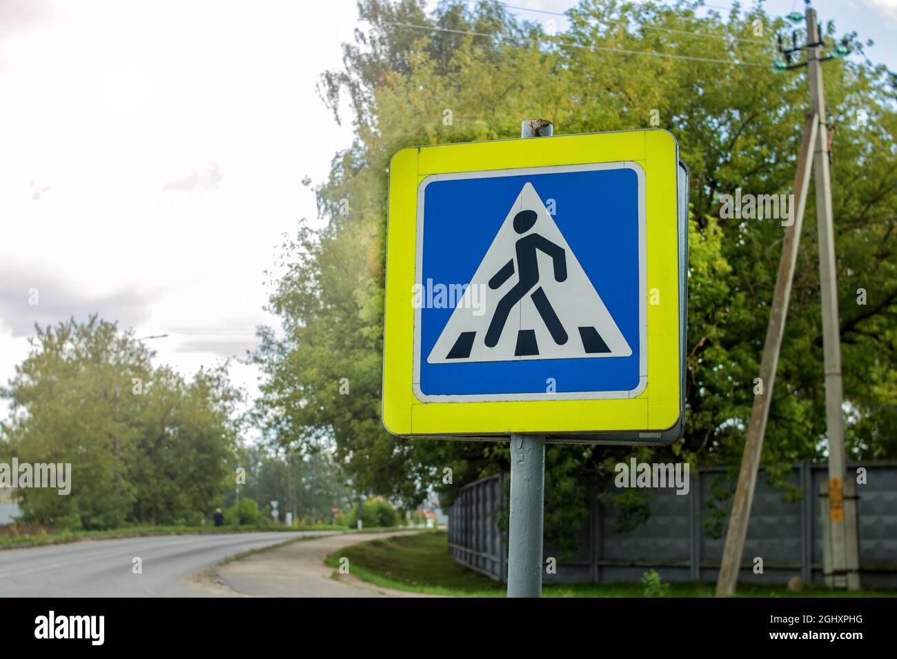 Pedestrian crossing sign near the road close up Stock Photo - Alamy