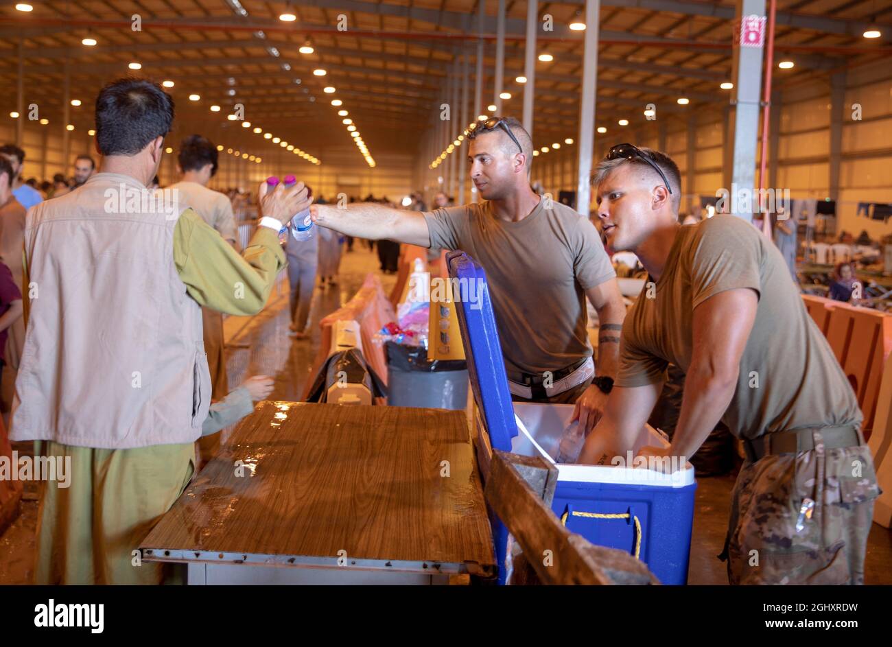 U.S. Army Soldiers hand out water to Afghan evacuees at Al Udeid Air ...