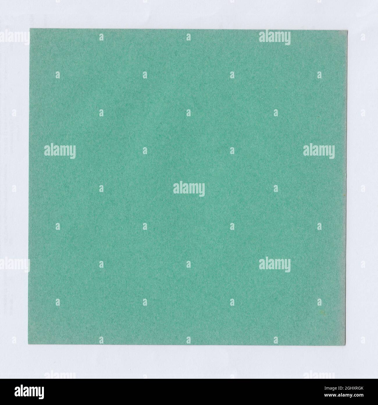 50 year old green folding paper against a white background. A little ...