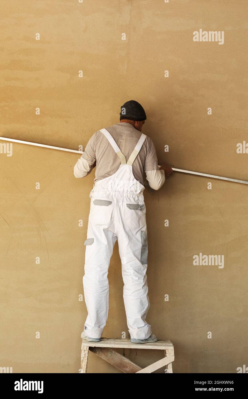 Plaster trimming process. Interior finishing works Stock Photo - Alamy