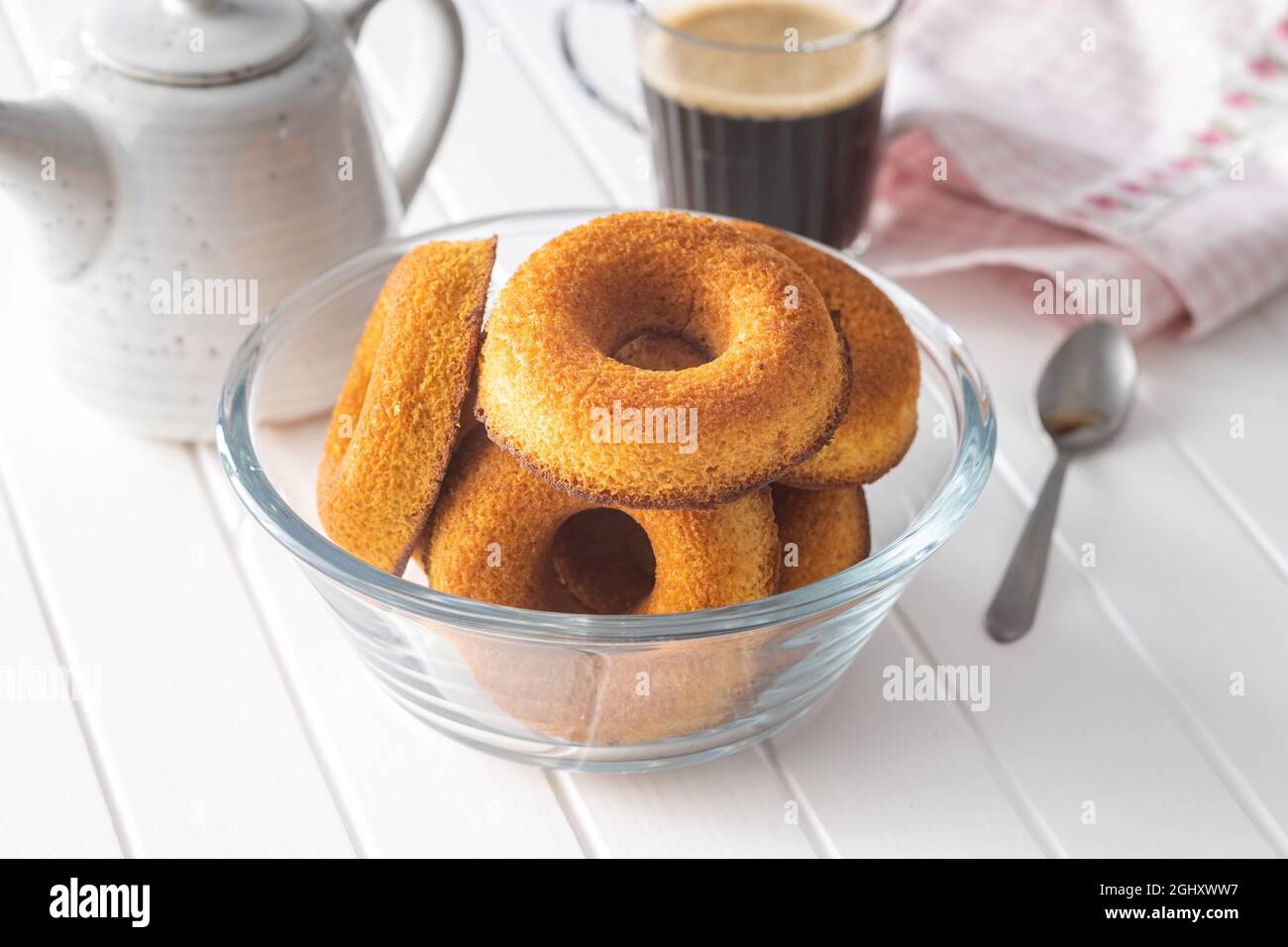 Round sponge cake dessert. Sweet donut on white table Stock Photo - Alamy