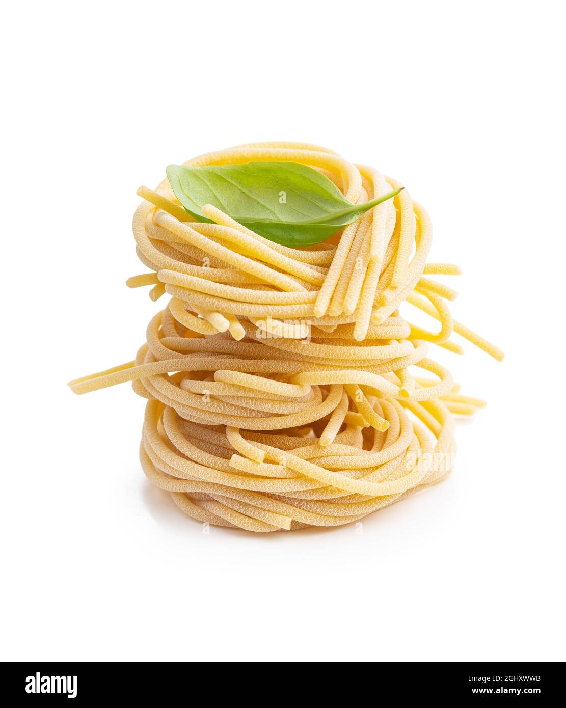 Italian pasta nest. Uncooked spaghetti nest isolated on white ...