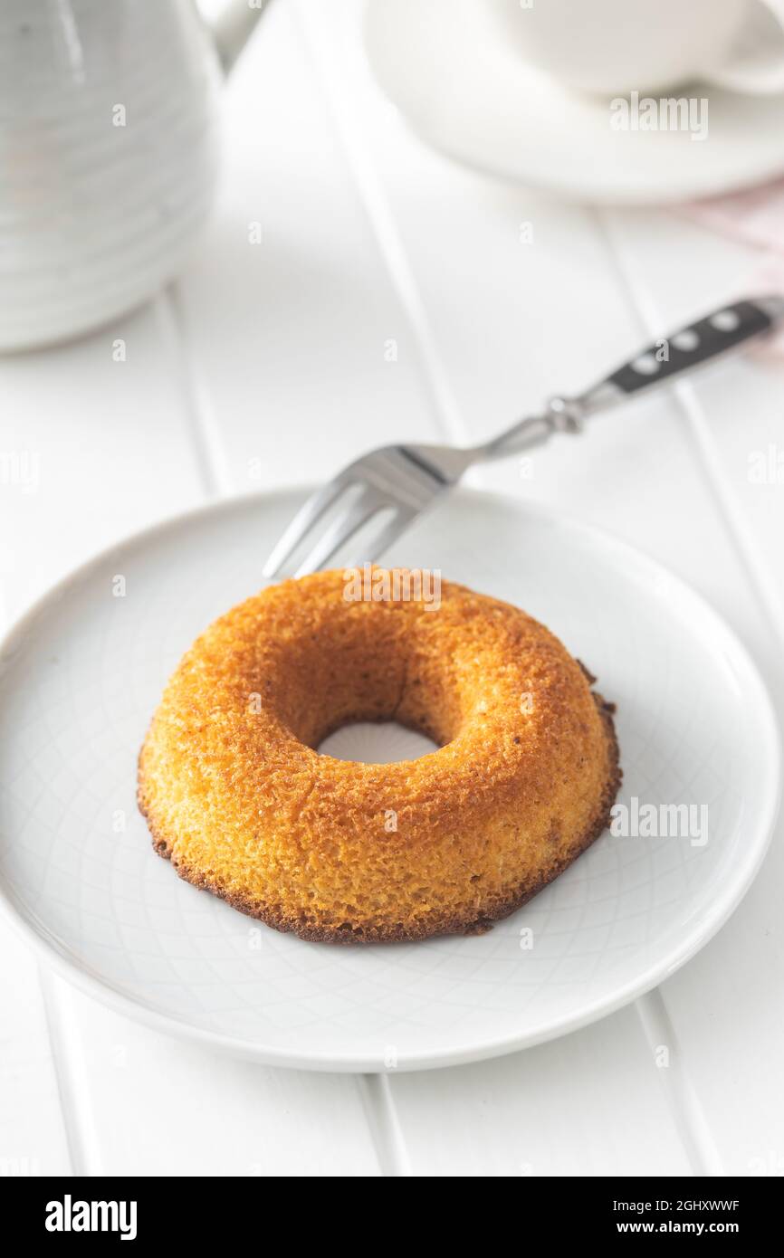 Round sponge cake dessert. Sweet donut on white table Stock Photo - Alamy