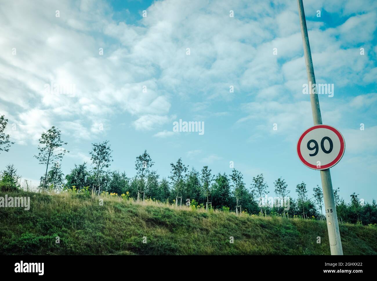 90 speed restriction road sign with sky on the background Stock Photo ...