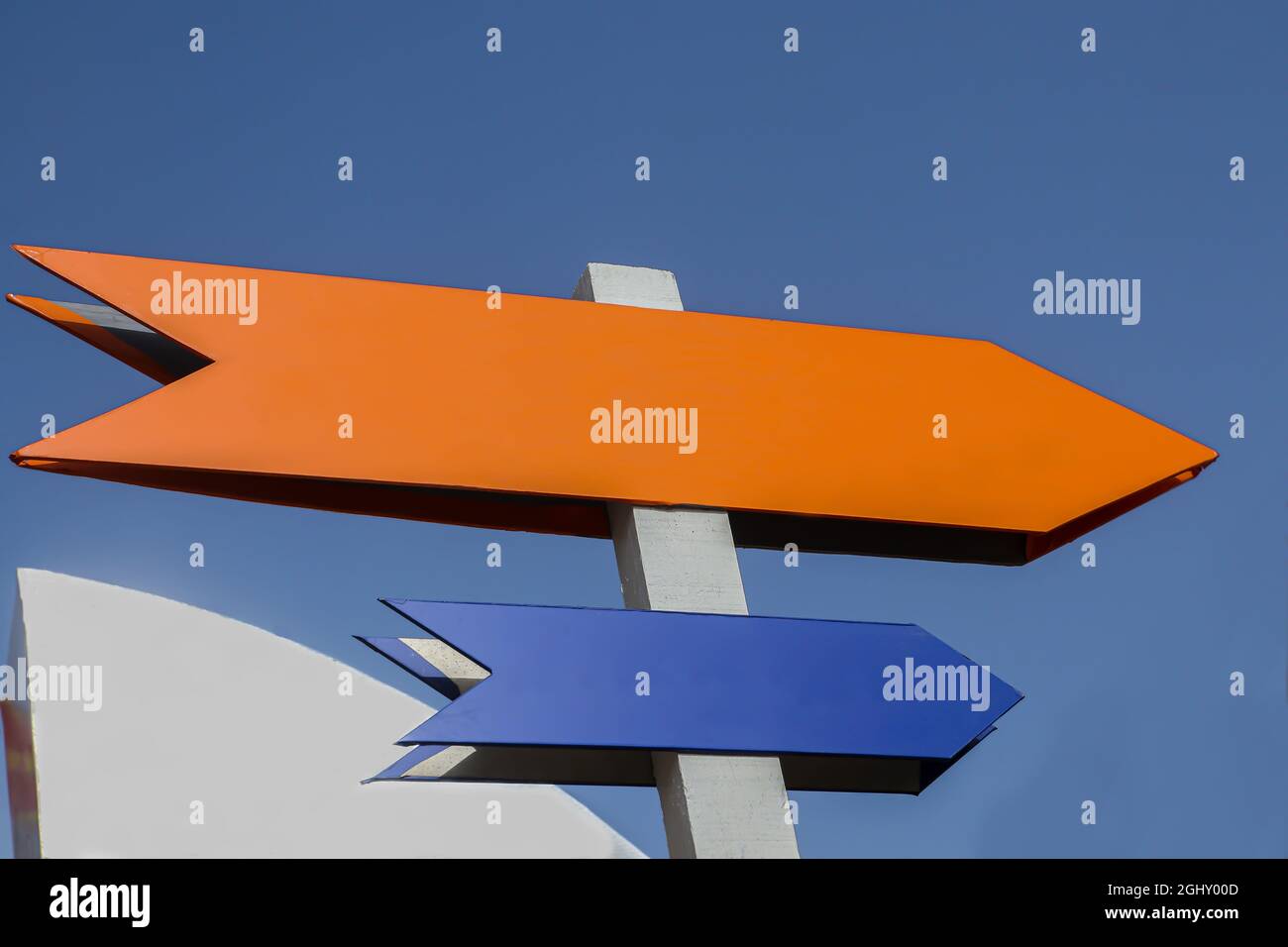 Orange And Blue Directional Blank Arrow-shaped Signpost And Blue Sky ...