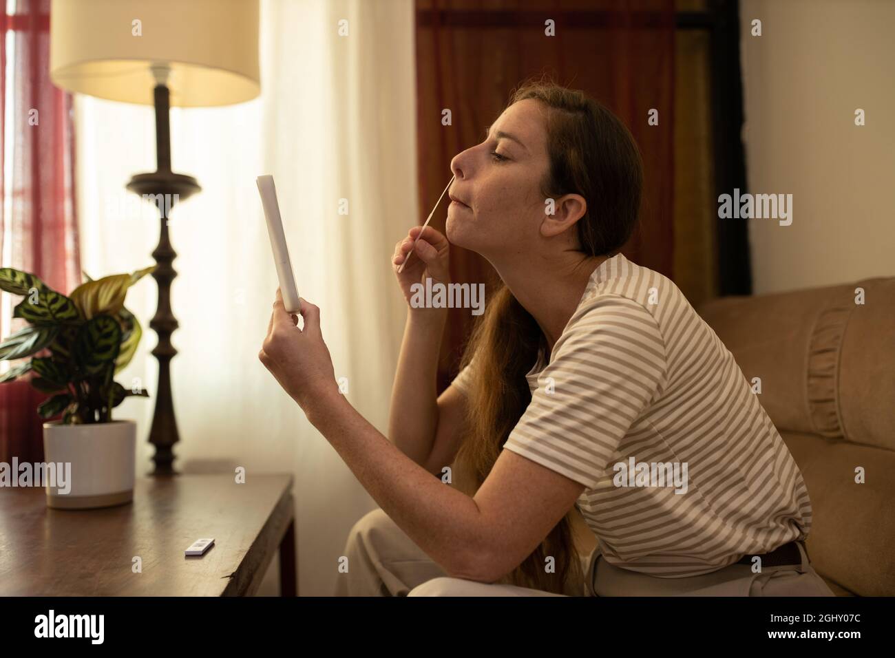 Woman performs a Covid-19 self-test at home Stock Photo - Alamy