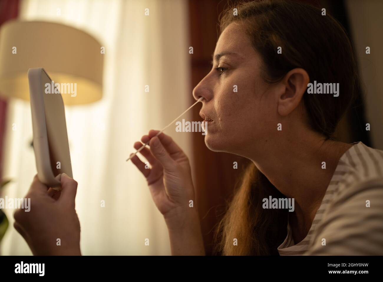 Woman performs a Covid-19 self-test at home Stock Photo - Alamy