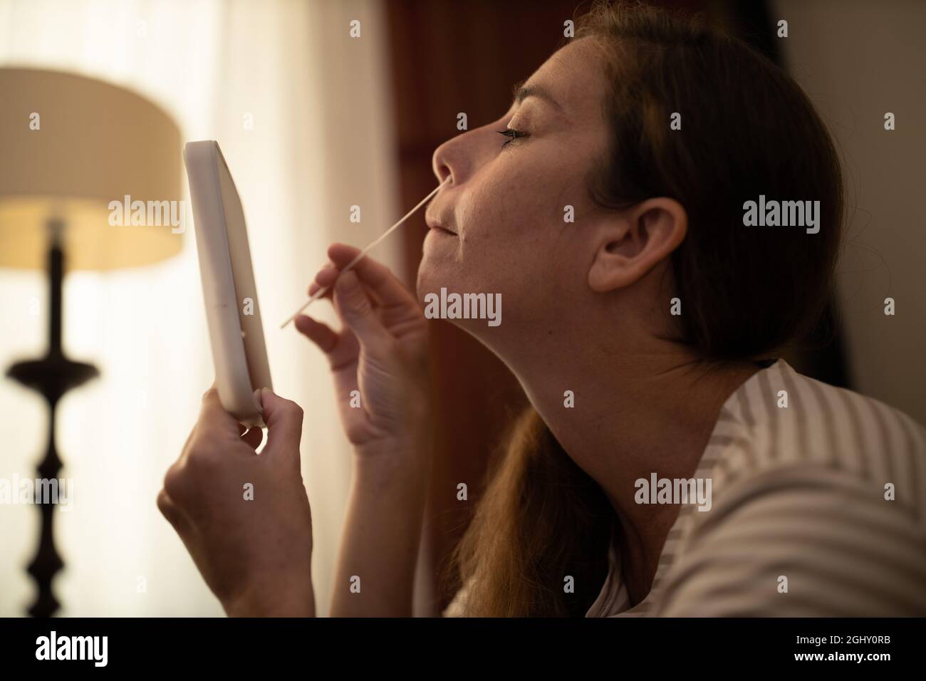 Woman performs a Covid-19 self-test at home Stock Photo - Alamy