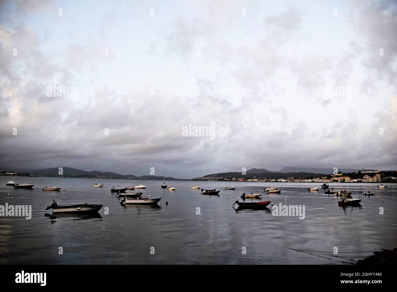 Group of boats floating on a seaport under a cloudy sky Stock Photo - Alamy