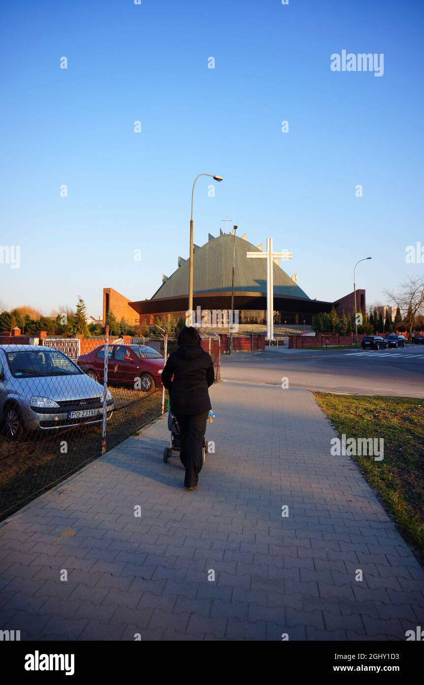 POZNAN, POLAND - Mar 18, 2015: A vertical shot of a person walking with ...