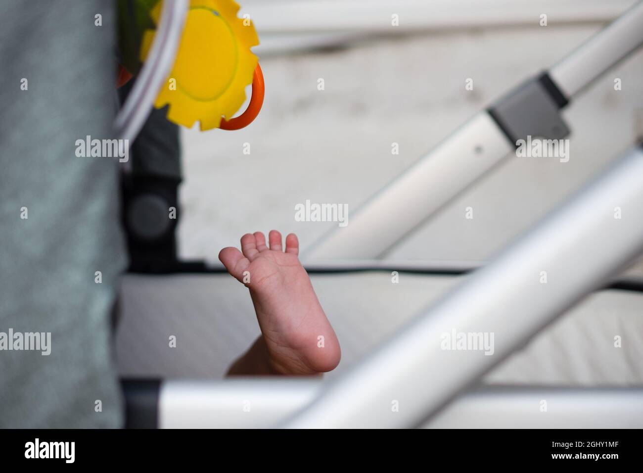 Closeup of a baby's foot popping out of a baby carriage outdoors Stock ...