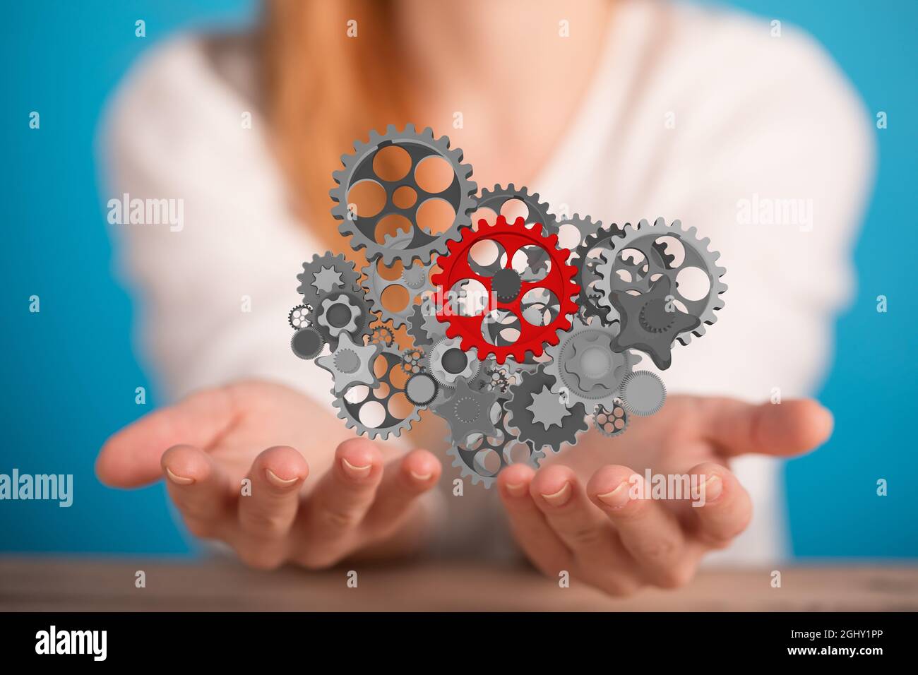 3D rendering of red and gray gears hovering over a female's hands Stock ...