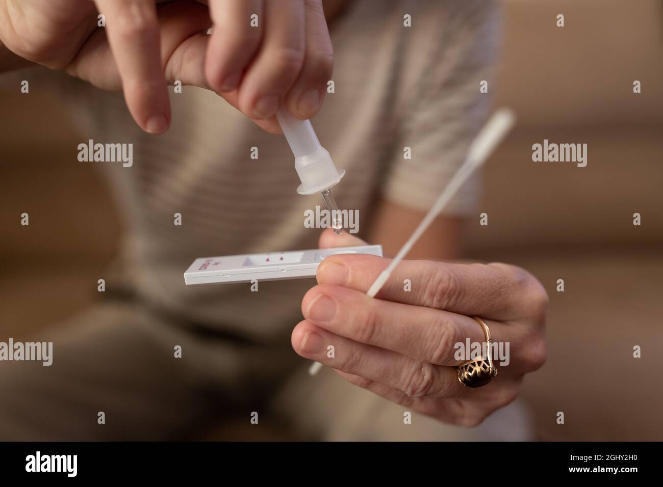 Woman performs a Covid-19 self-test at home Stock Photo - Alamy