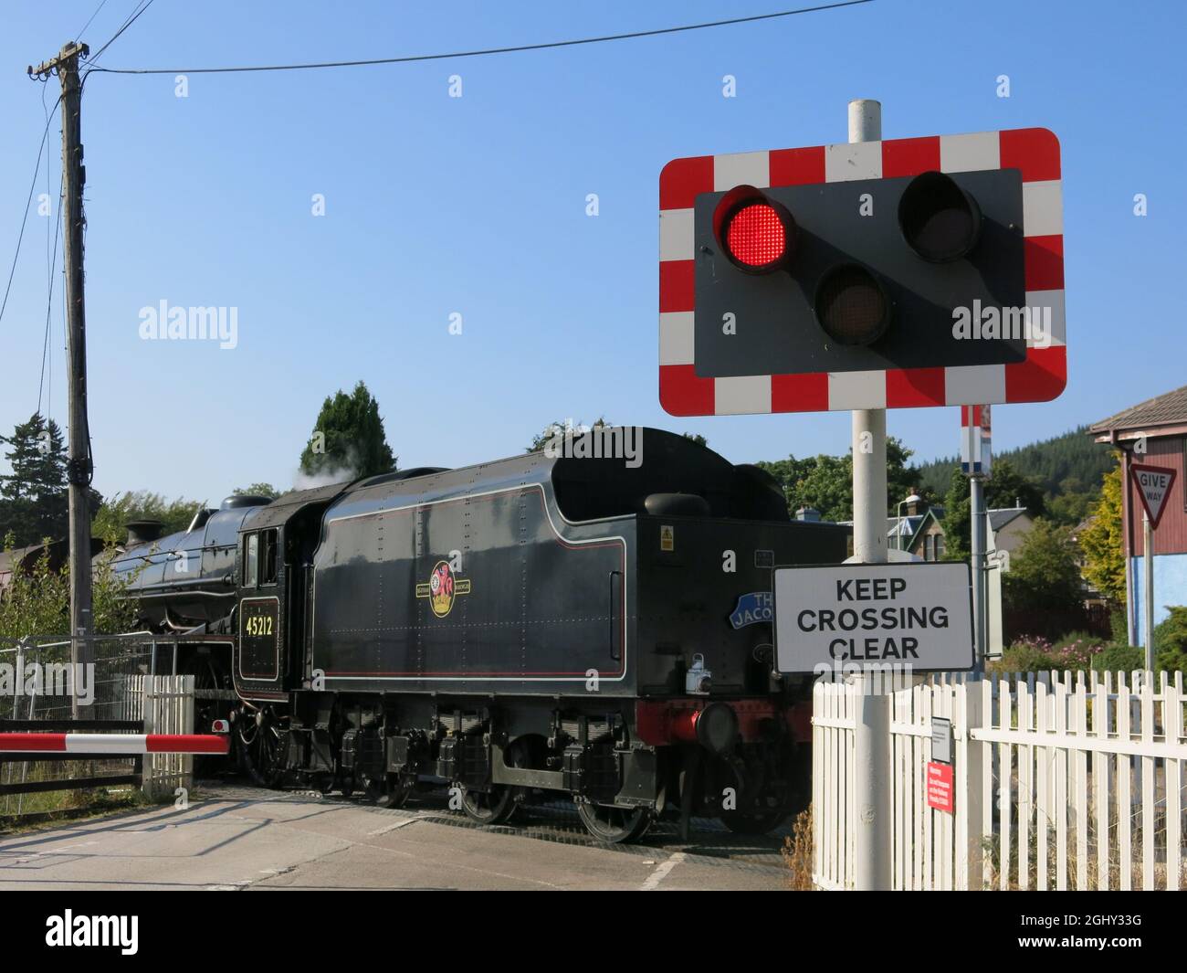 Red warning lights for the Jacobite steam train at the level crossing ...