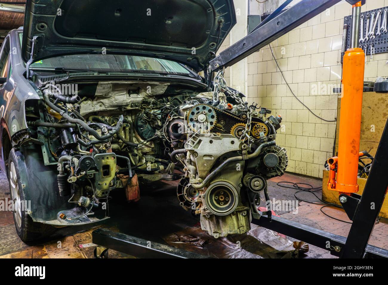 dismantling a damaged engine from a car with the help of a folding ...