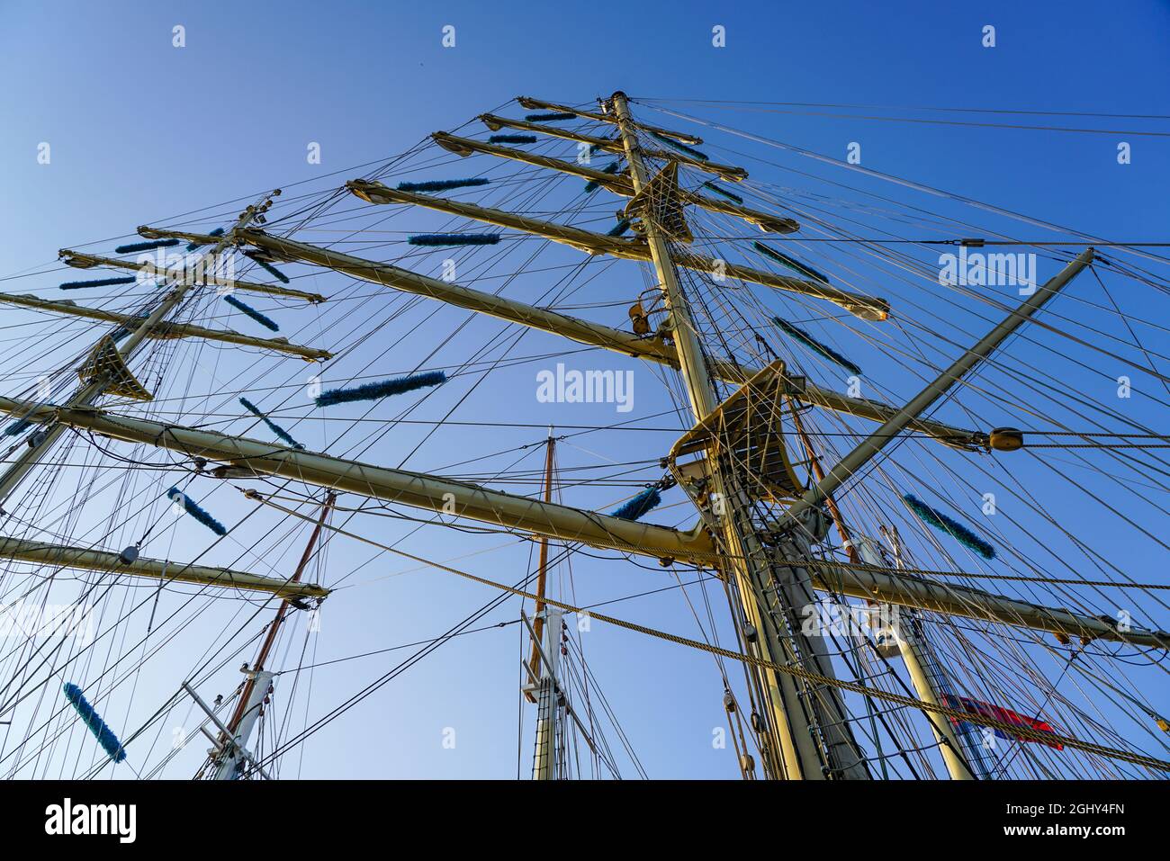 large sailing ship masts with many ropes on a blue sky background Stock ...