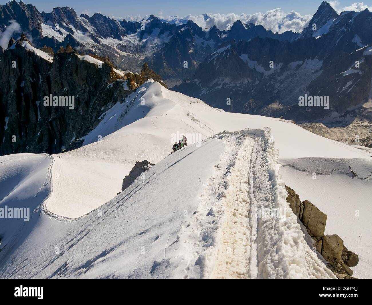 French Alps mountains snowy ridge view with silhouettes of climbers as ...