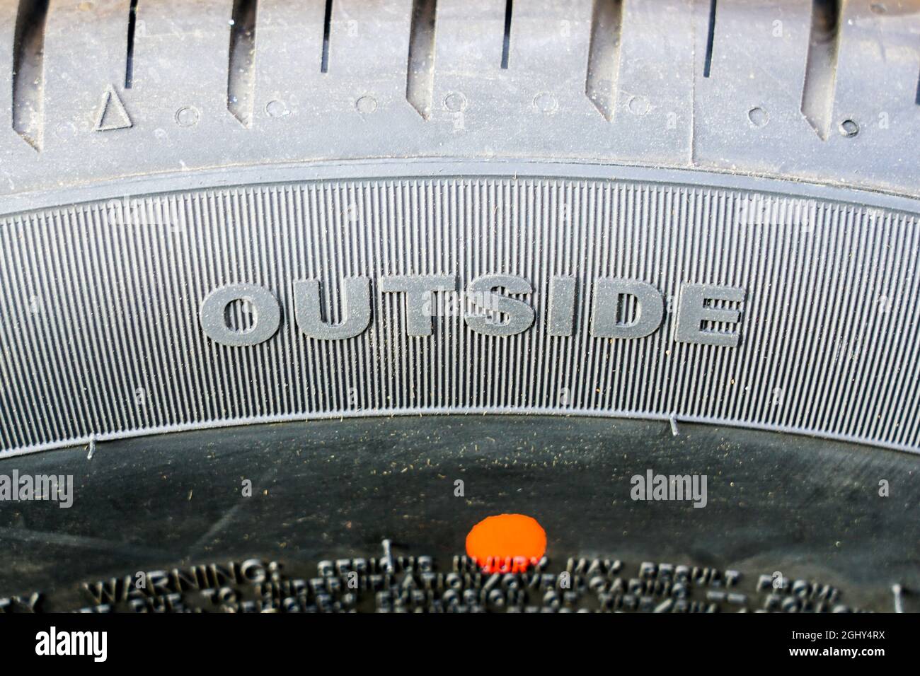 text on tire sidewall indicating direction for wearing the tires on the ...