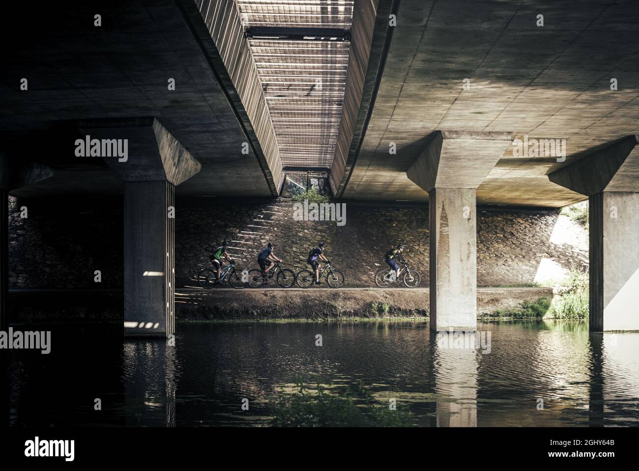 a group of people cylcing through an underpass on cycle track Stock ...