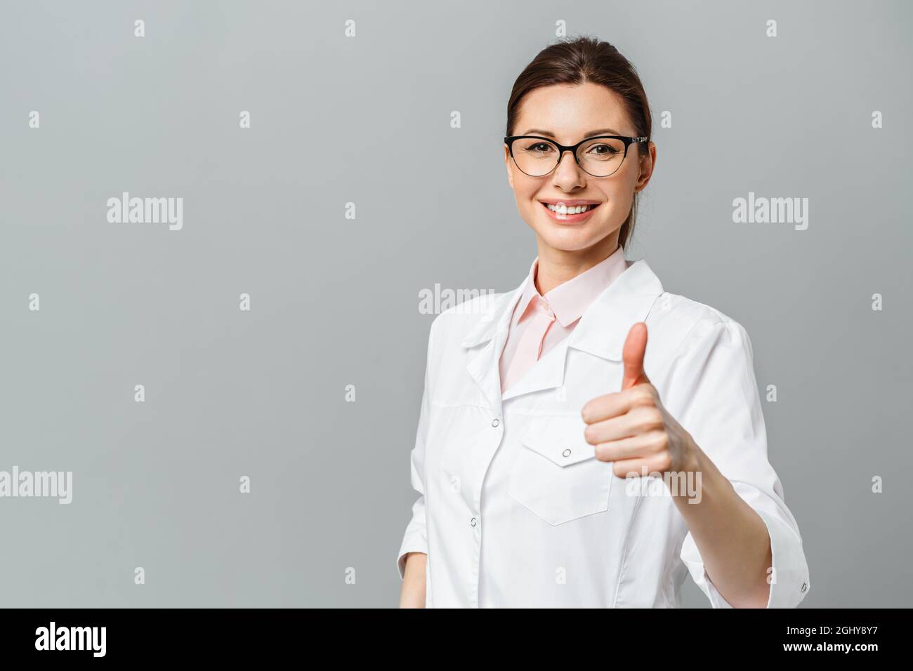 Portrait of a happy female doctor showing the OK sign Stock Photo - Alamy