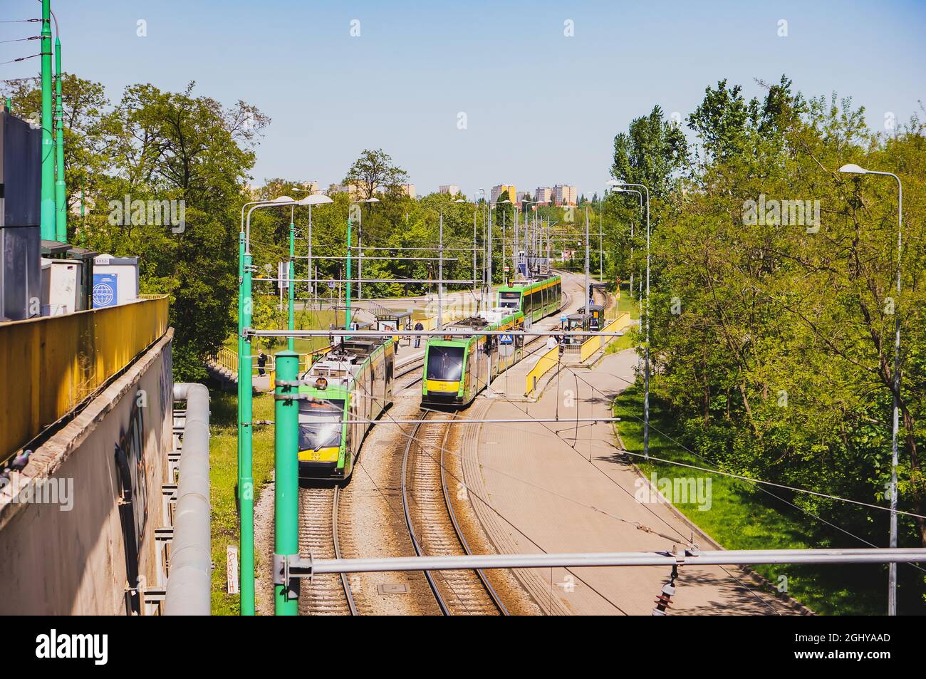 Green public transport trams on rails in the city center of Poznan ...