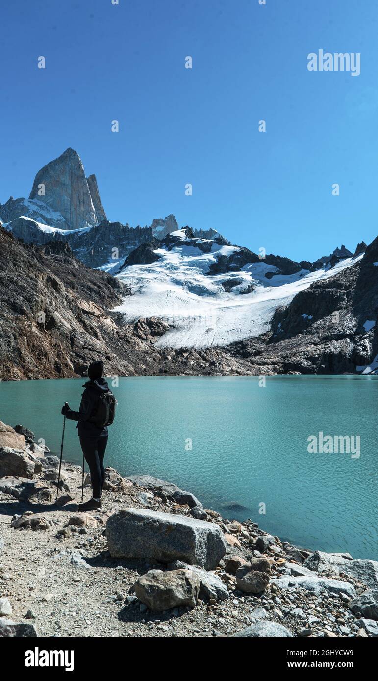 Young woman on the edge of the lagoon of the three, next to mount fitz ...