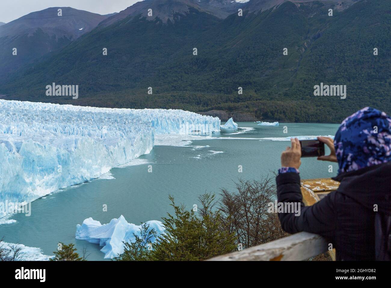 woman taking a photo with the cell phone to the Perito Moreno Glacier ...
