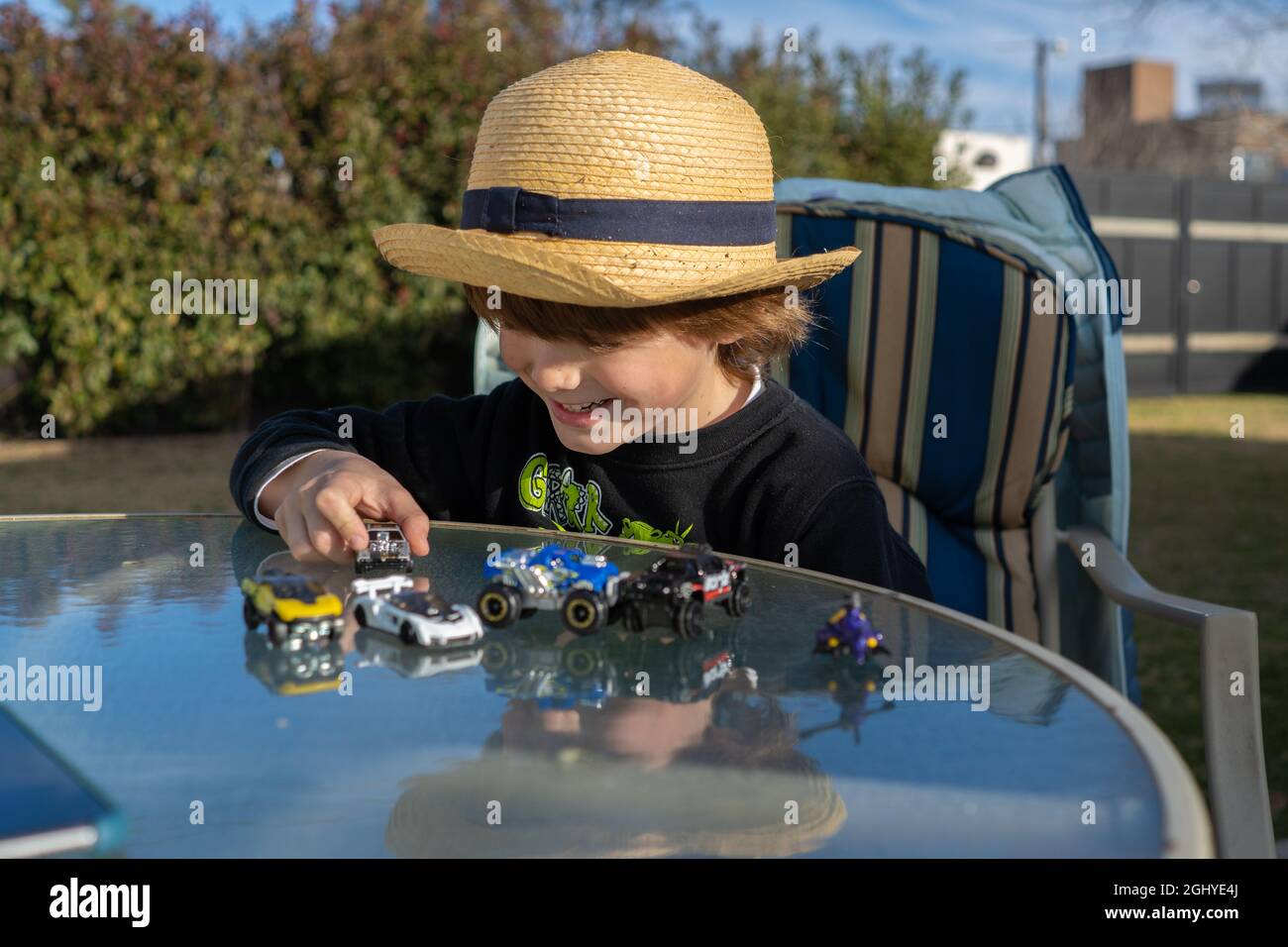 White Caucasian little kid playing outdoors with his toys Stock Photo ...