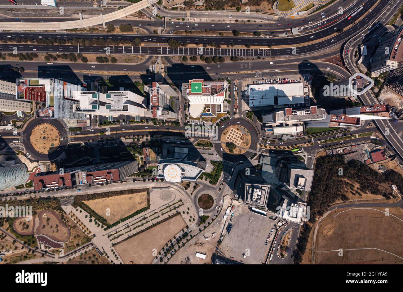 Birds eye view of rooftop of building and skyscrapers with empty street ...