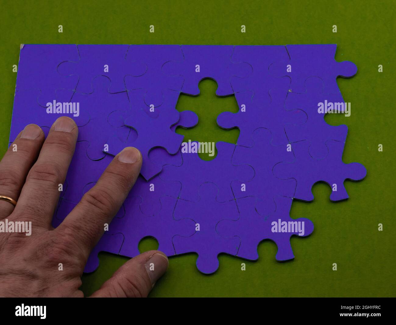 hand composing puzzle Stock Photo - Alamy