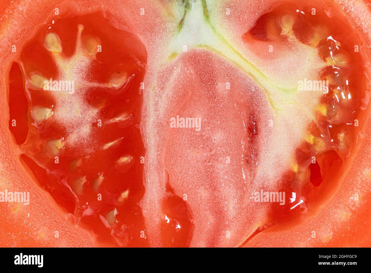 A whole red tomato and slice Texture Stock Photo - Alamy