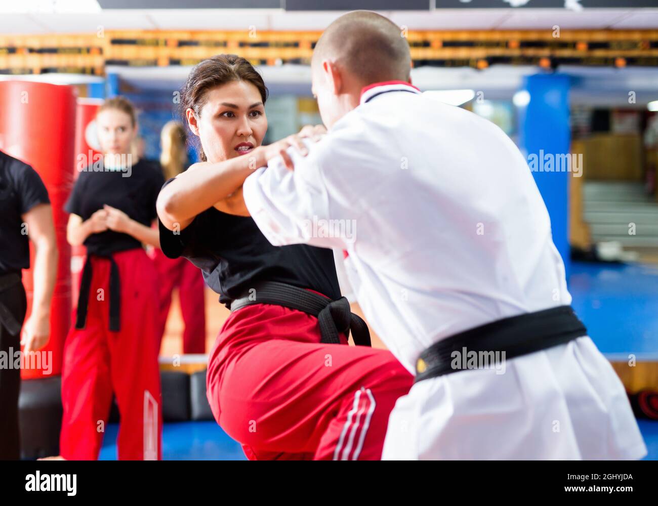 Woman doing knee strike Stock Photo - Alamy