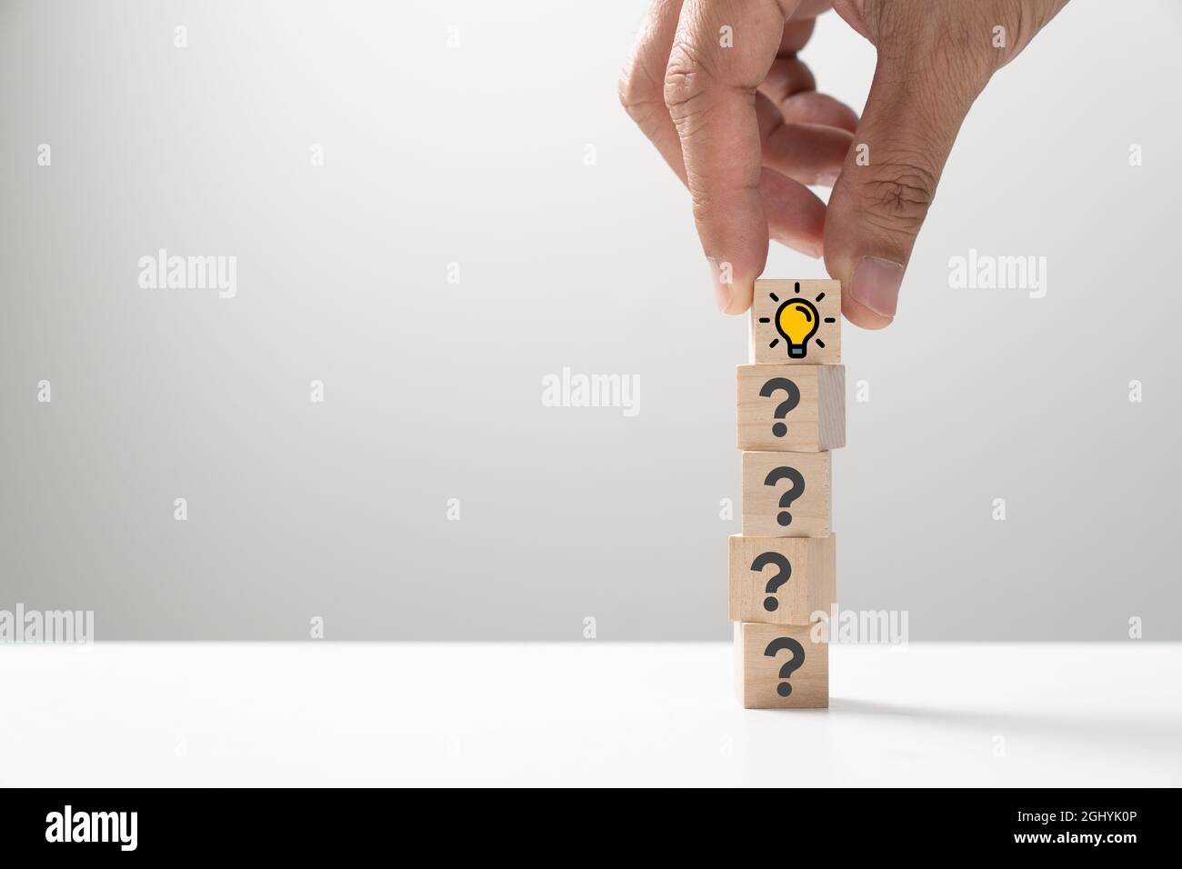 Vertical wooden block in question mark and lightbulb Stock Photo - Alamy
