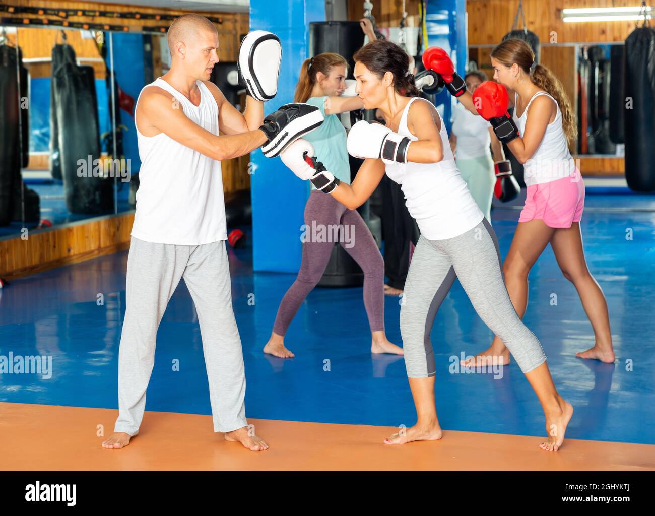 Asian woman in boxing gloves during self defense workout Stock Photo ...