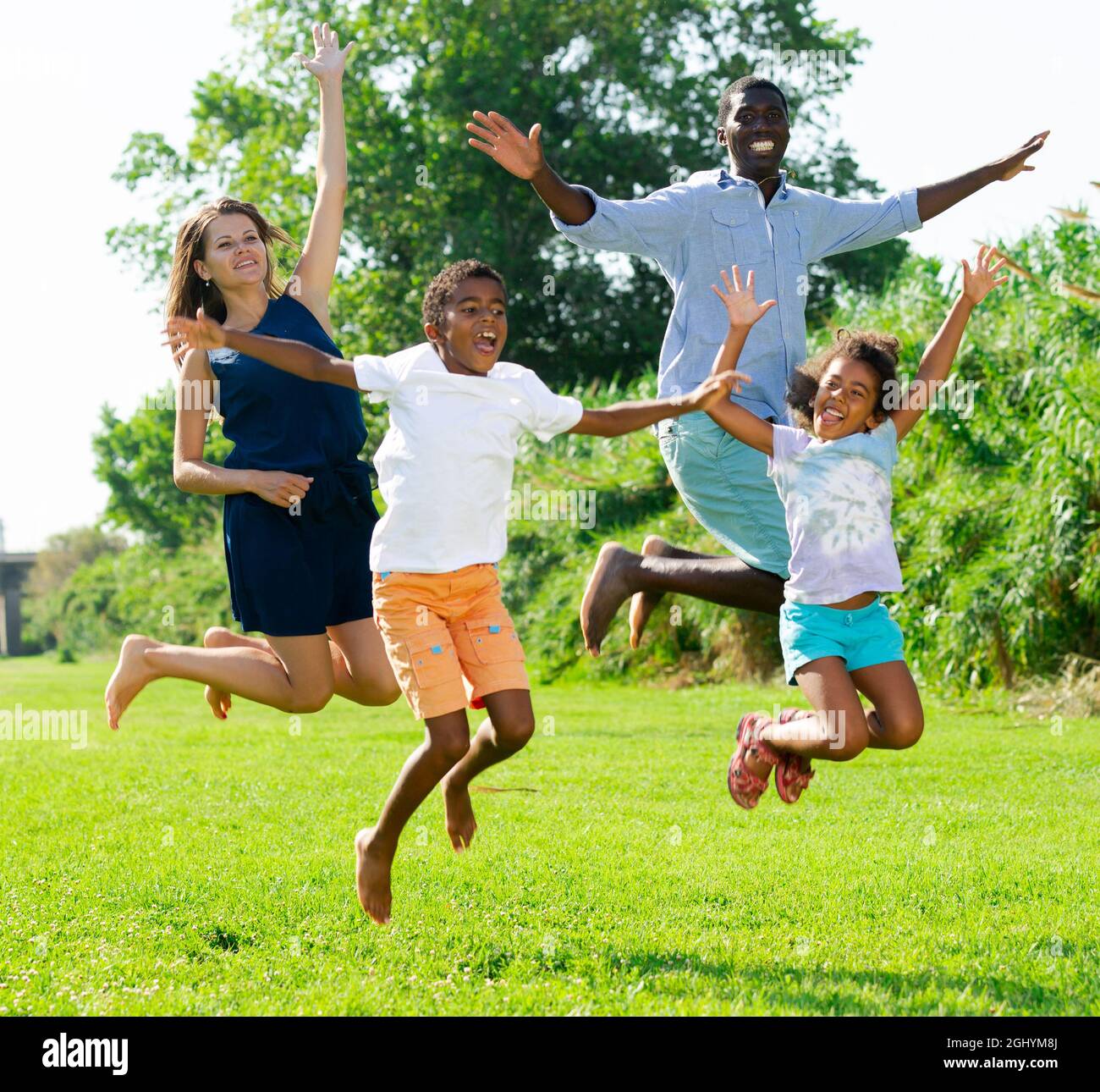 Cheerful family jumping Stock Photo - Alamy