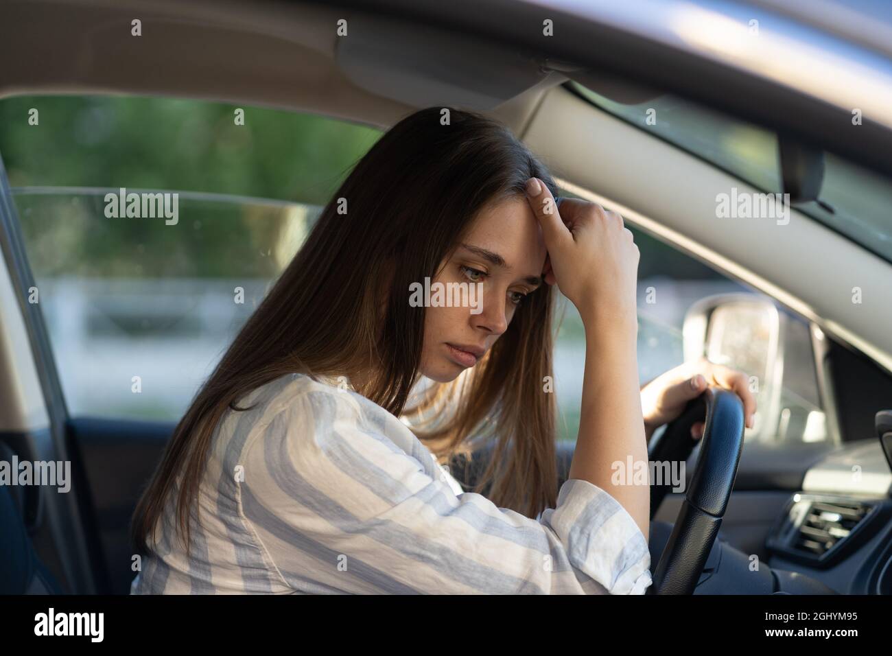 Sad young girl suffer stressed drive car. Unhappy female driver think ...