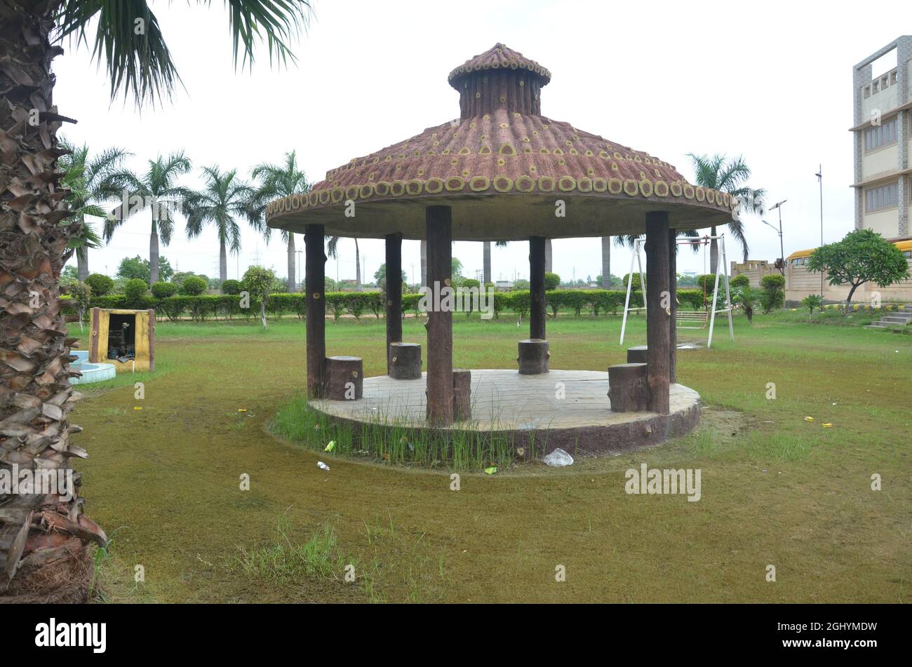 Cemented shelter or hut in the park with benches Stock Photo - Alamy