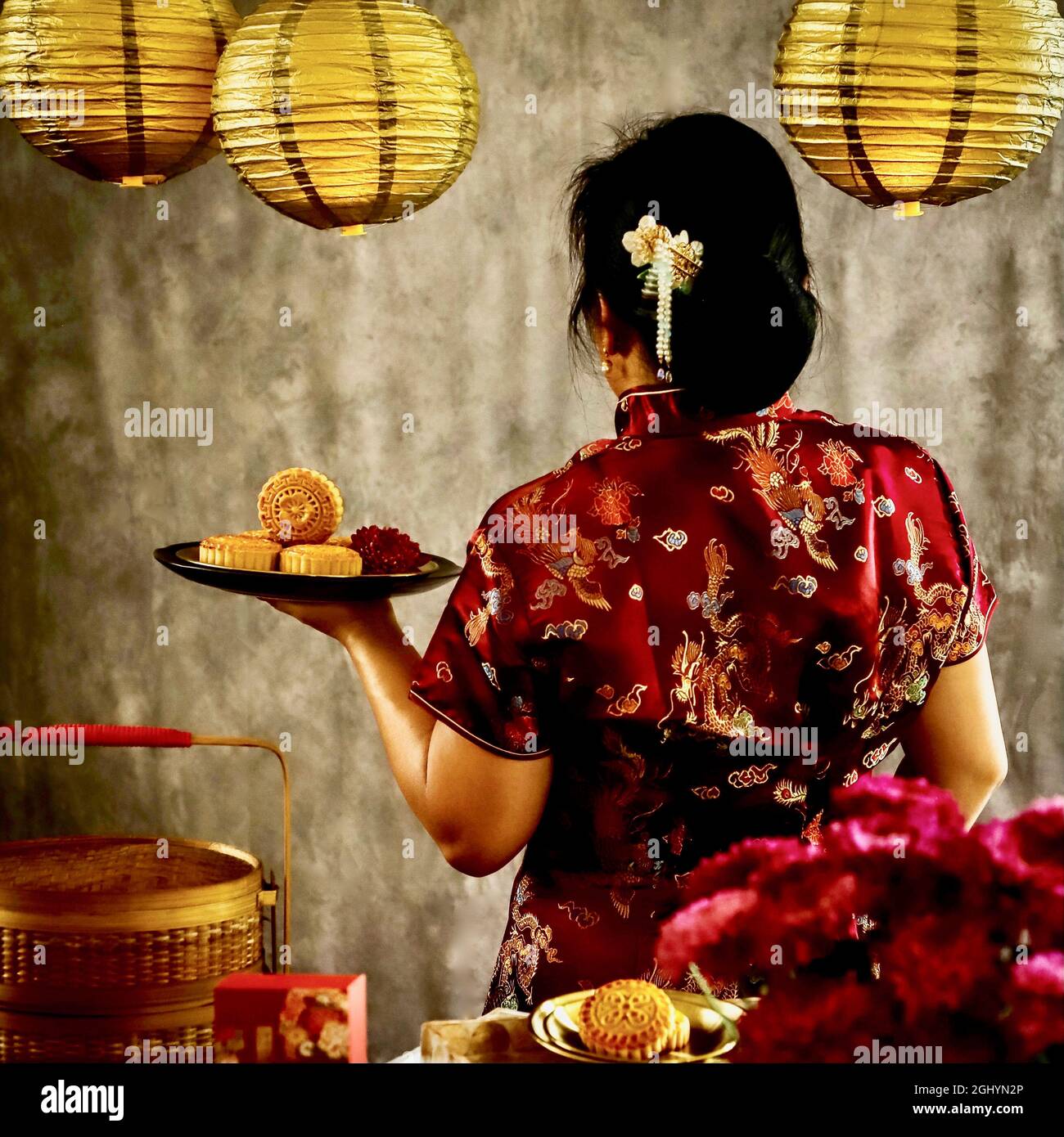 A Chinese Peranakan lady holding a platter of mooncakes for Mid-Autumn ...
