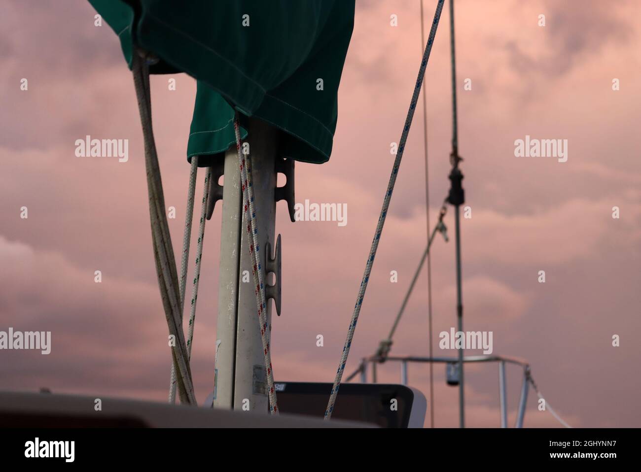 Sailboat mast, boom and rigging with view of pastel sky Stock Photo - Alamy