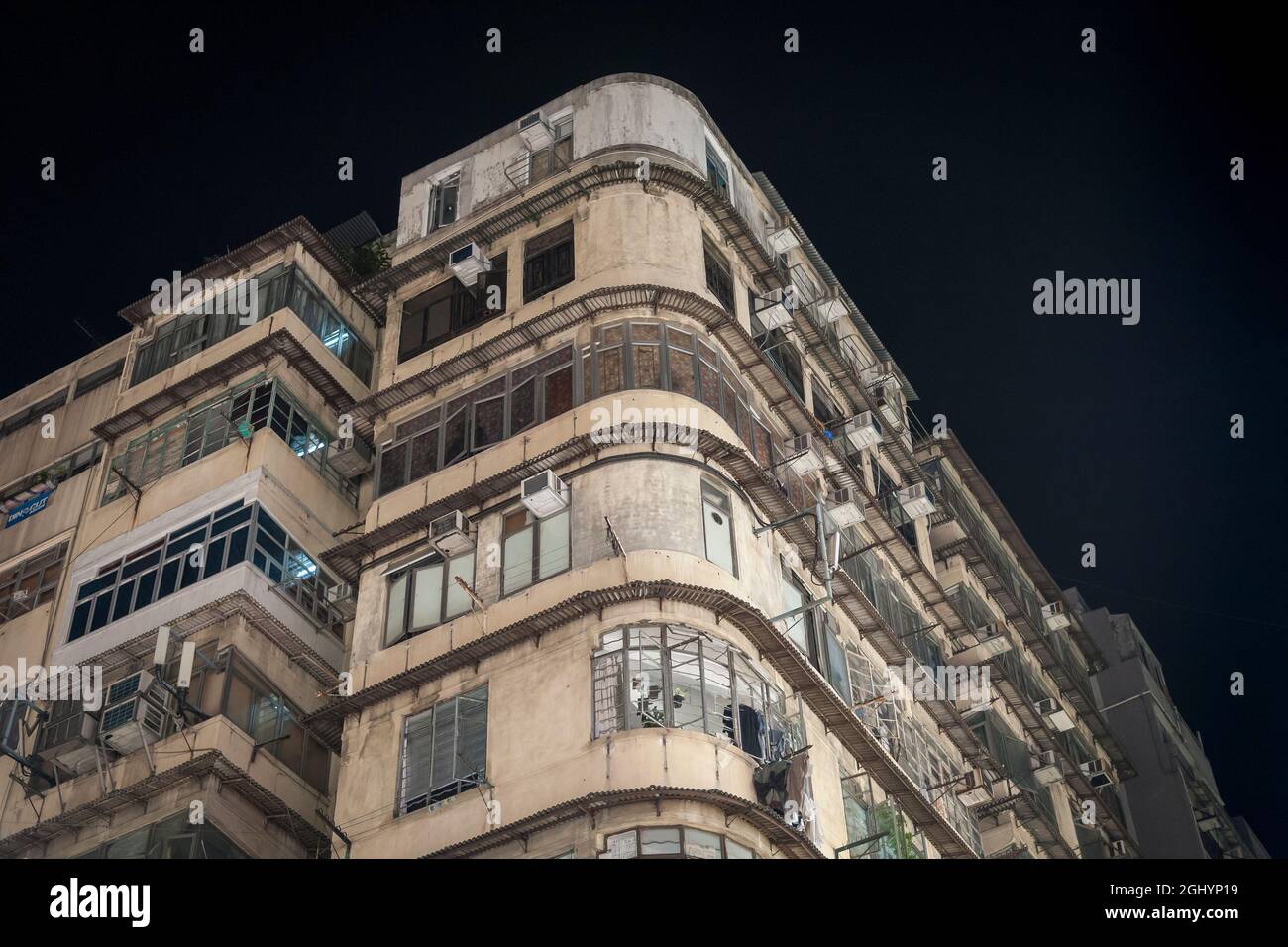 A 1960s-style tenement building at night in Mong Kok, Kowloon, Hong ...